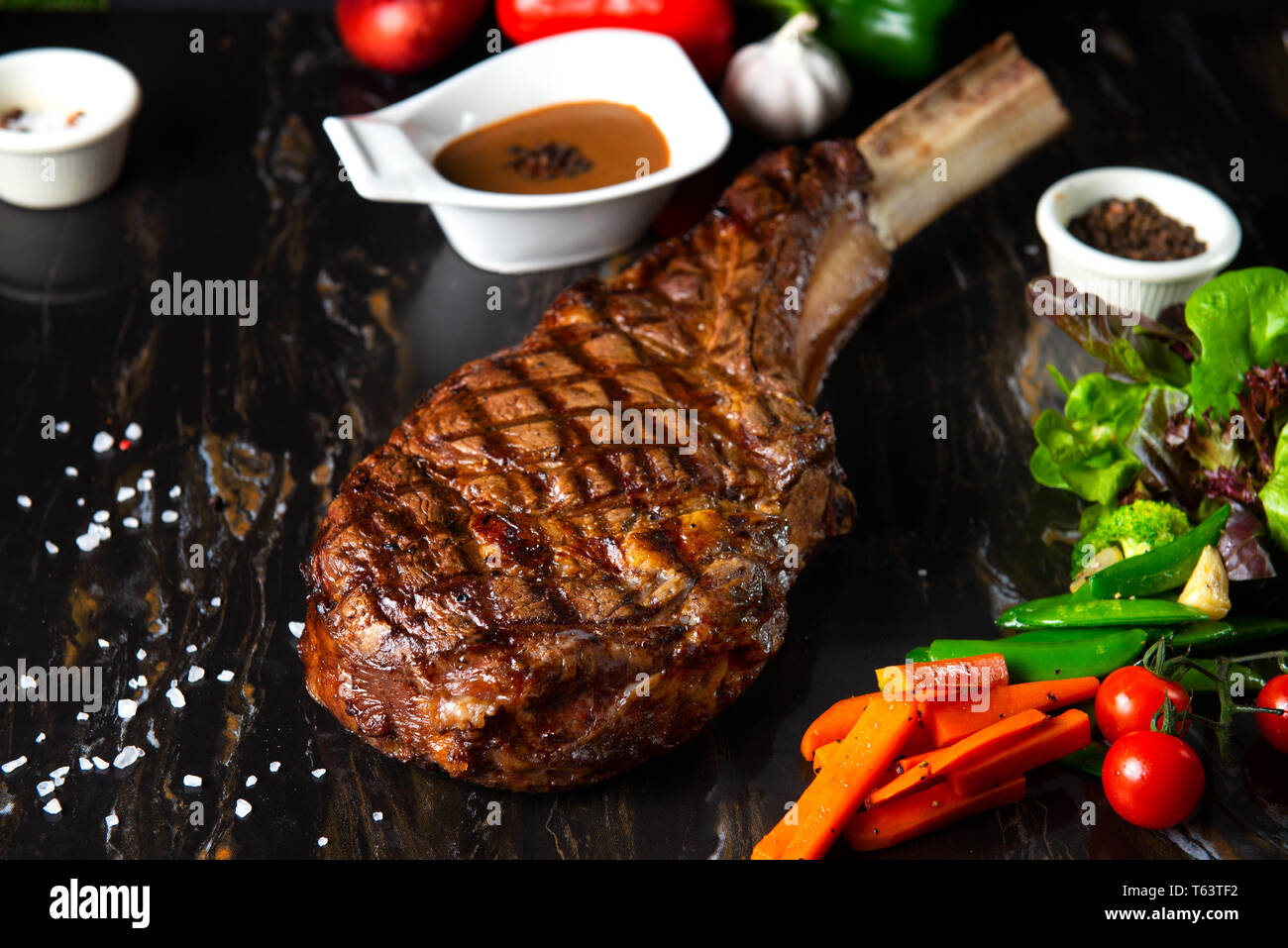beautifully seared tomahawk steak, medium rare to rare Stock Photo - Alamy
