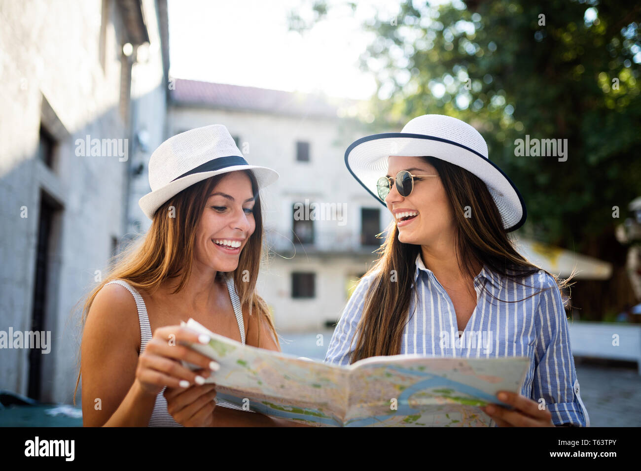 Young happy tourists women sightseeing in city on vacation Stock Photo ...