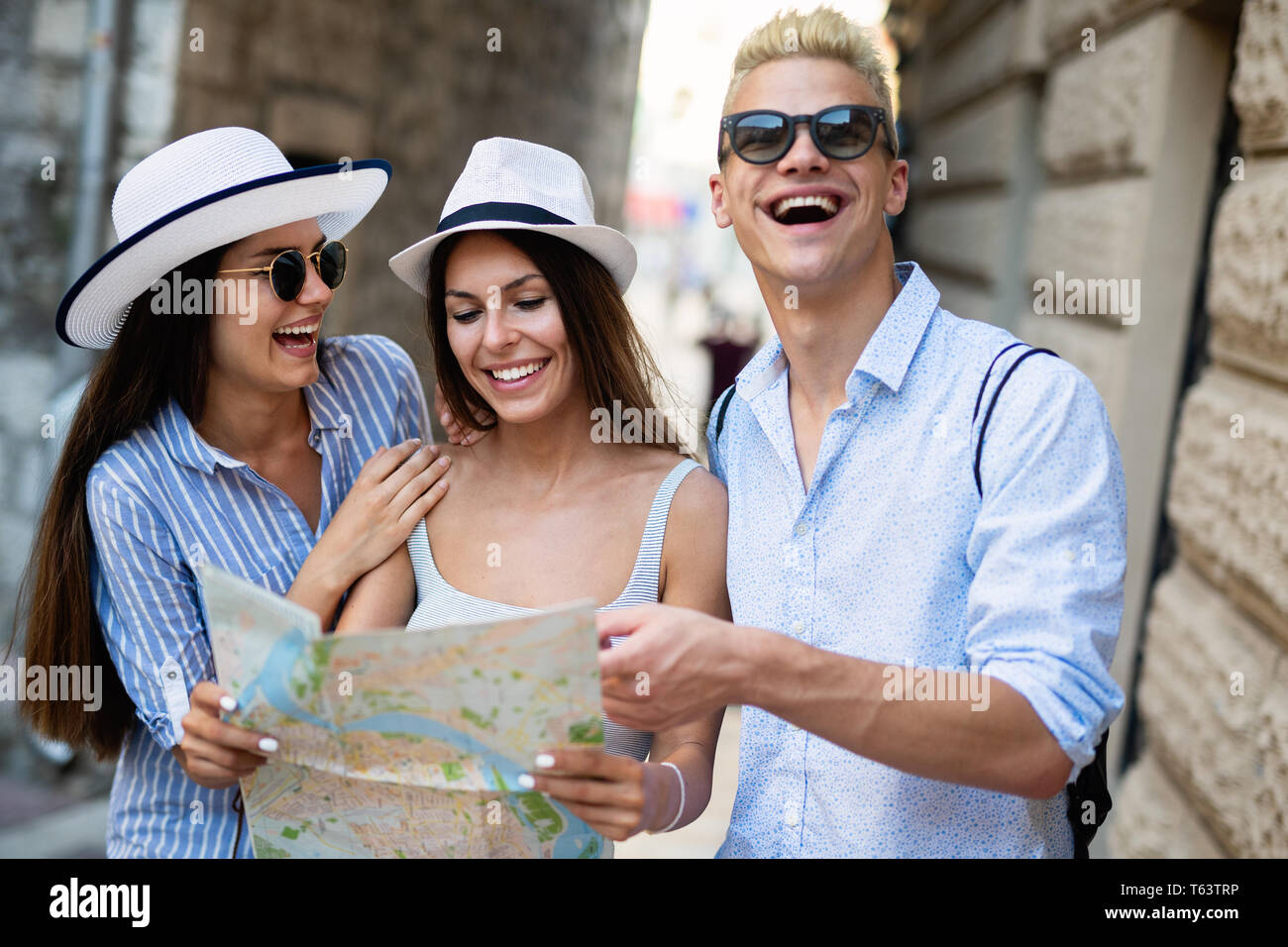 Happy group of tourists traveling and sightseeing together at summer ...