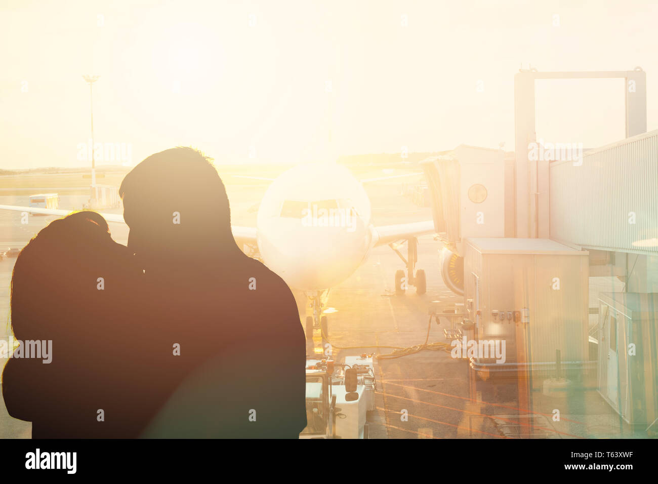 Couple kiss near window in airport. The concept of meeting or parting ...