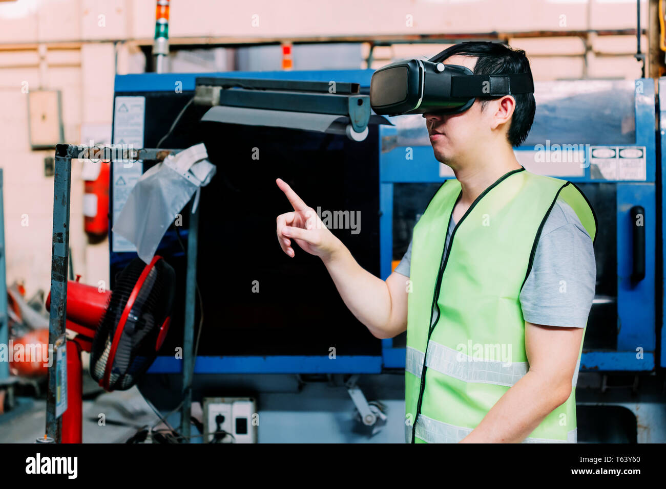 Industrial factory and manfacturing engieering worker wearing VR goggle ...