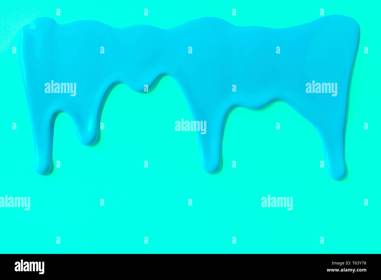 Blue paint leaking down trendy cyan background. Close up Stock Photo ...