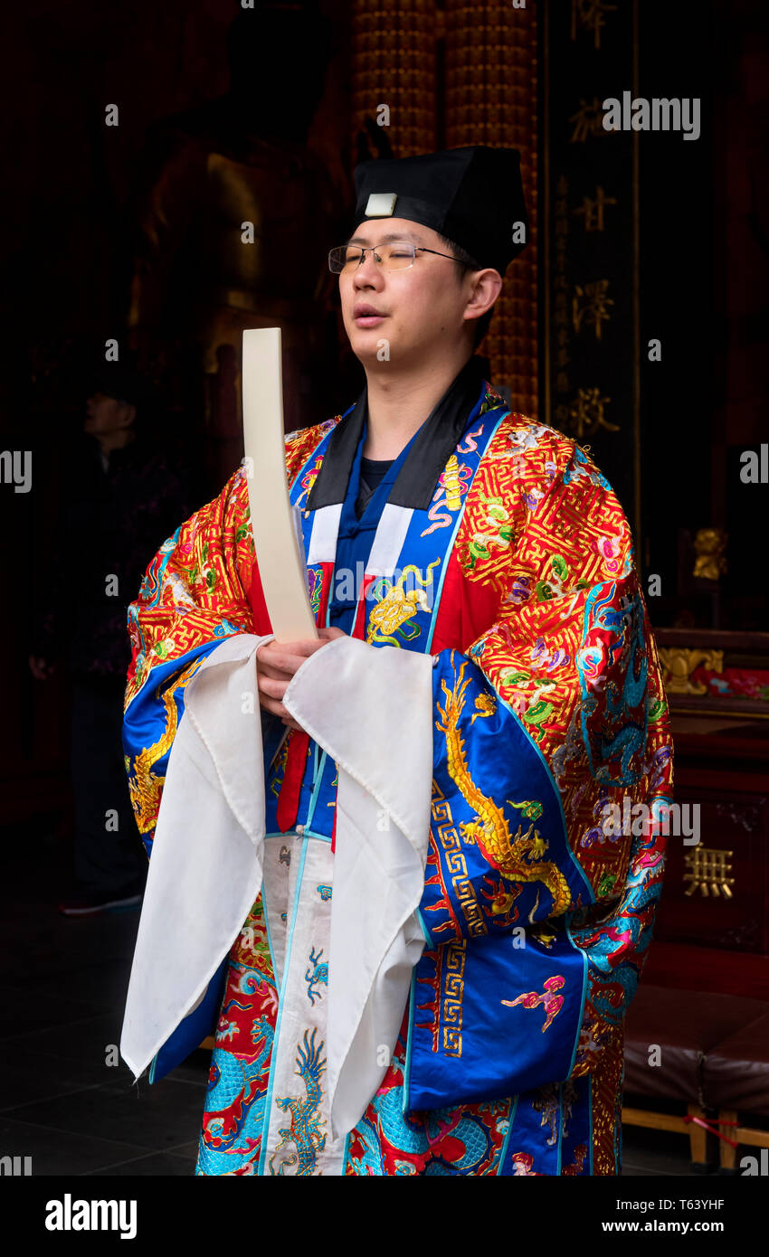 Taoist priest praying at the Temple of the Town Gods (or Temple of the ...