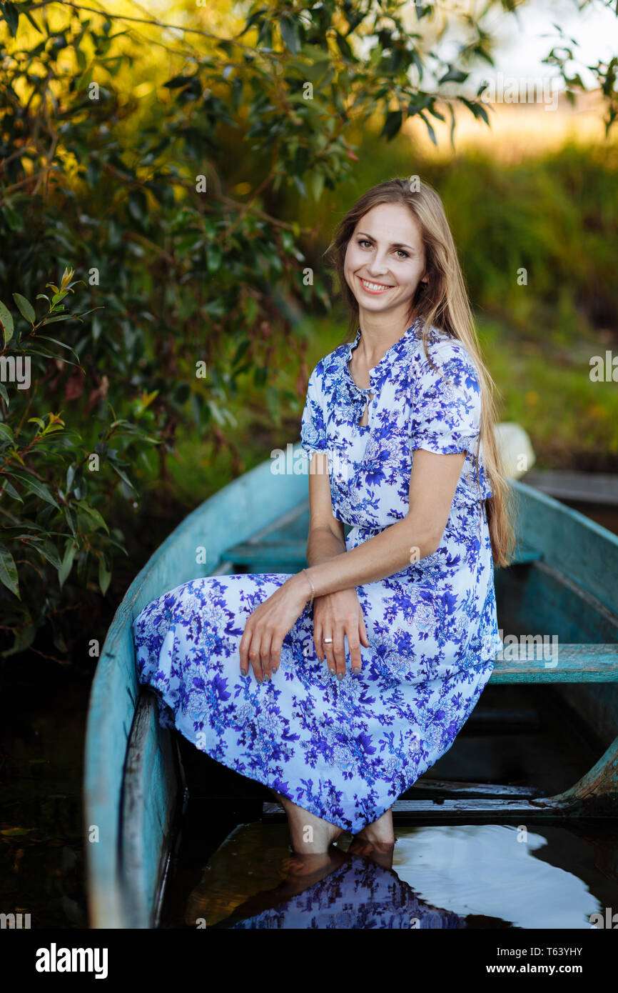 Lifestyle portrait of young beautiful woman sitting at motorboat. girl ...