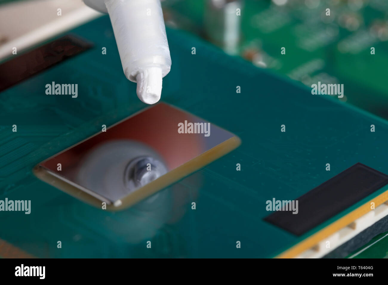 A tube of thermal grease over the processor chip. Computer assembly ...