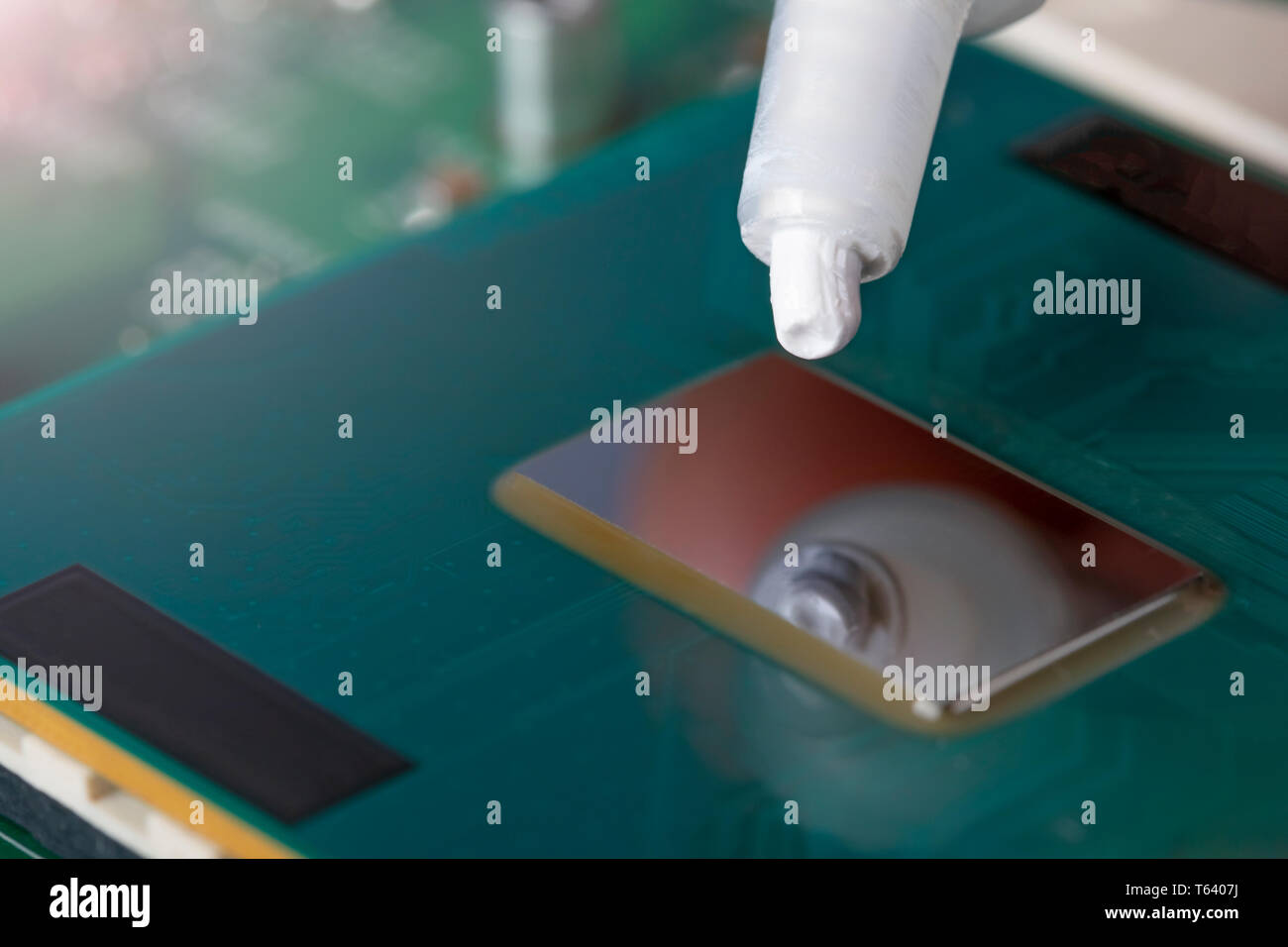 A tube of thermal grease over the processor chip. Computer assembly ...