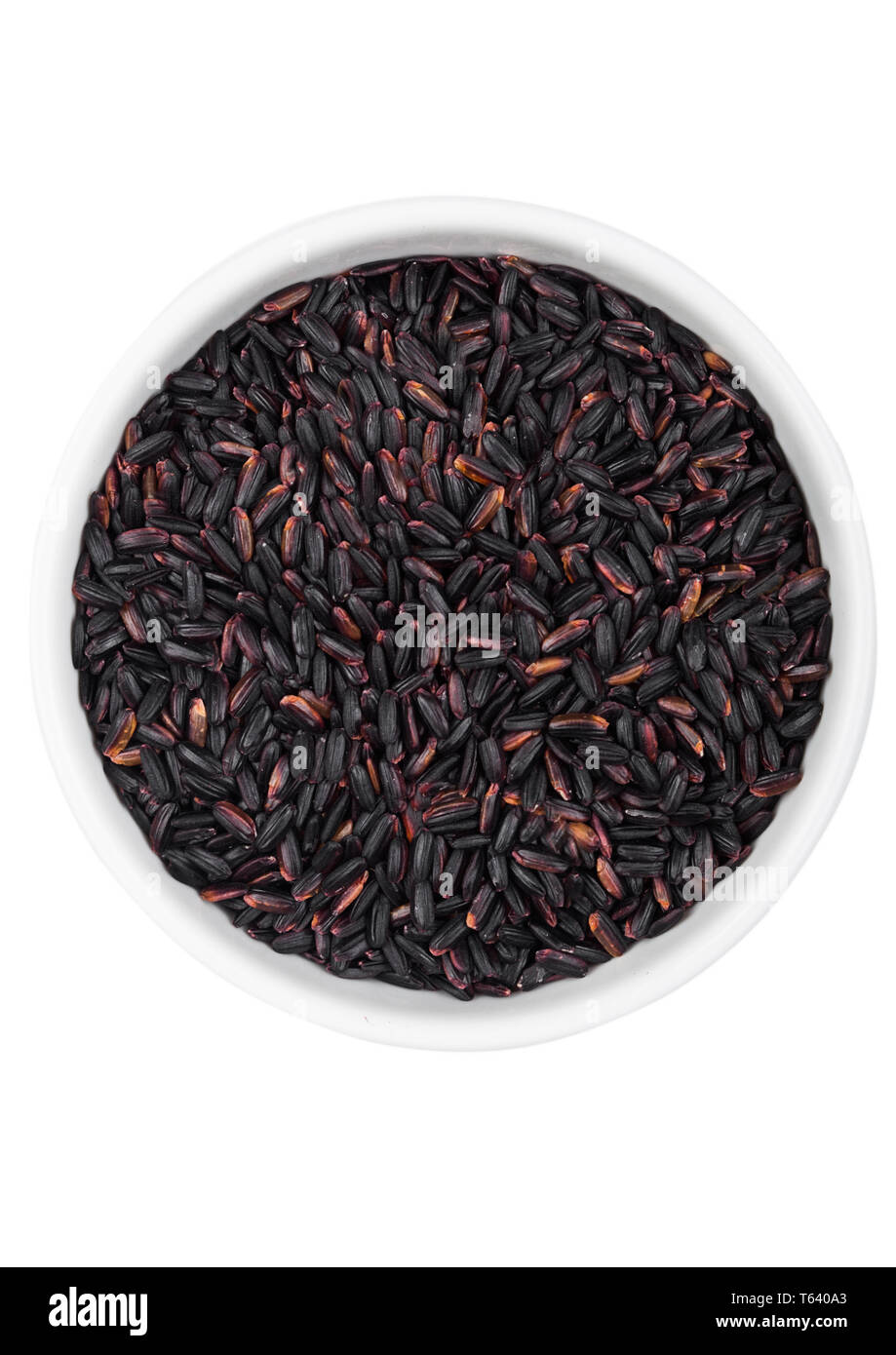 White bowl of raw organic black venus rice on white background. Top ...