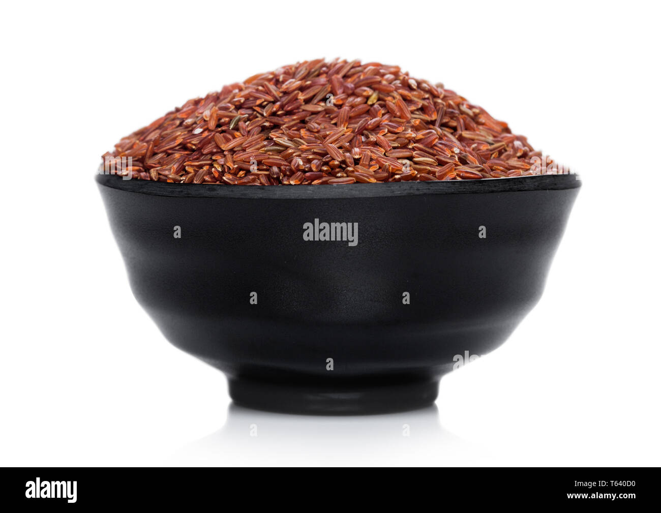 Black bowl of raw organic red rice on white background Stock Photo - Alamy