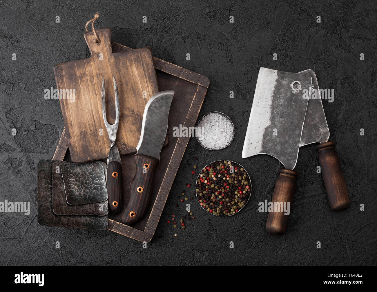 Vintage meat knife and fork and hatchets with vintage chopping board ...