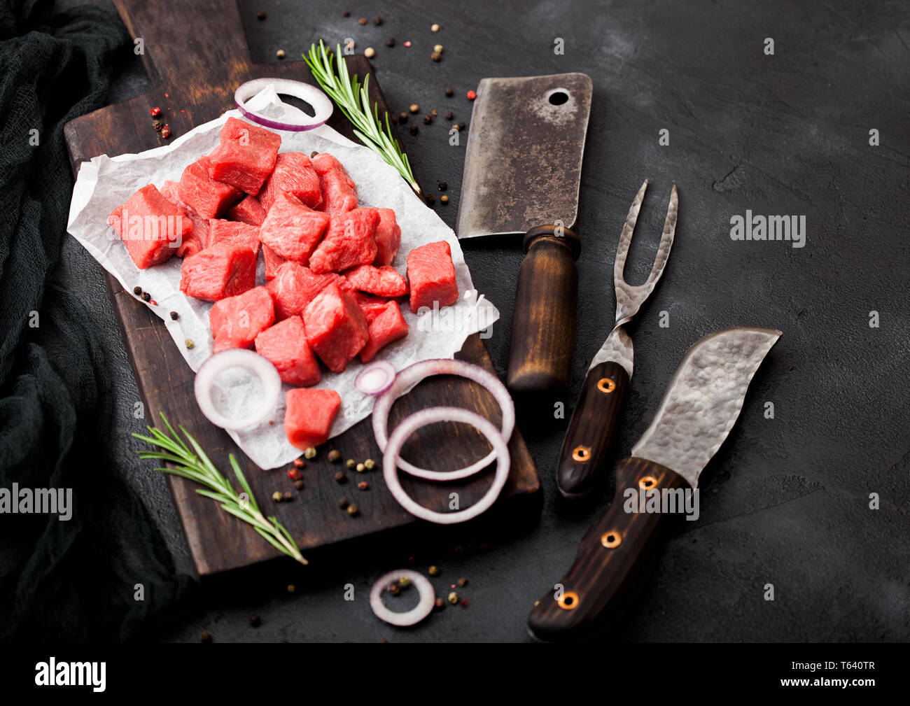 Raw lean diced casserole beef pork steak with vintage meat hatchet and ...