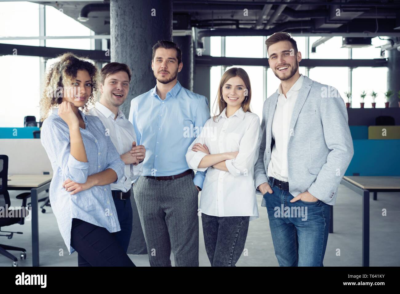 Successful friendly team with happy workers in office Stock Photo - Alamy