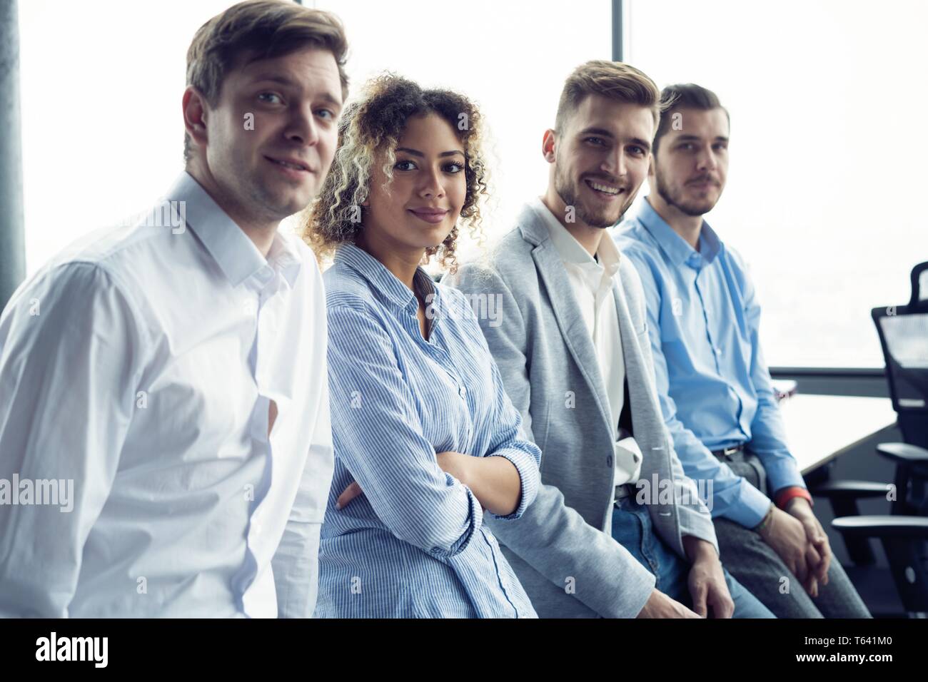 Successful friendly team with happy workers in office Stock Photo - Alamy