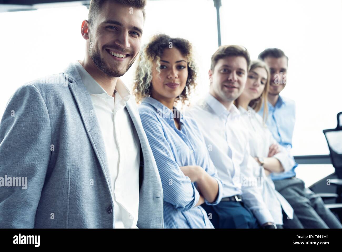 Successful friendly team with happy workers in office Stock Photo - Alamy