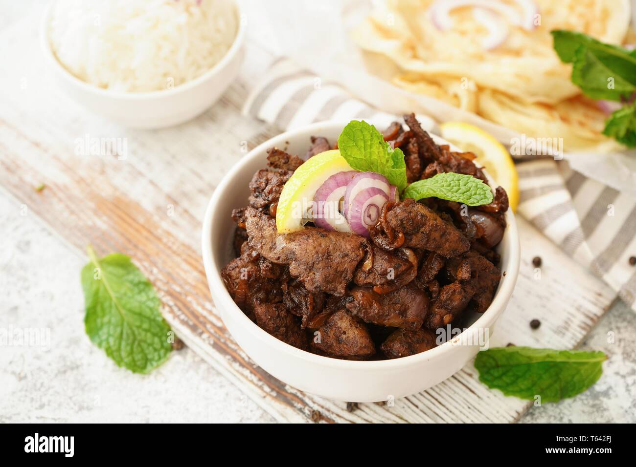 Beef Liver fry or roast served with rice and Roti, selective focus ...
