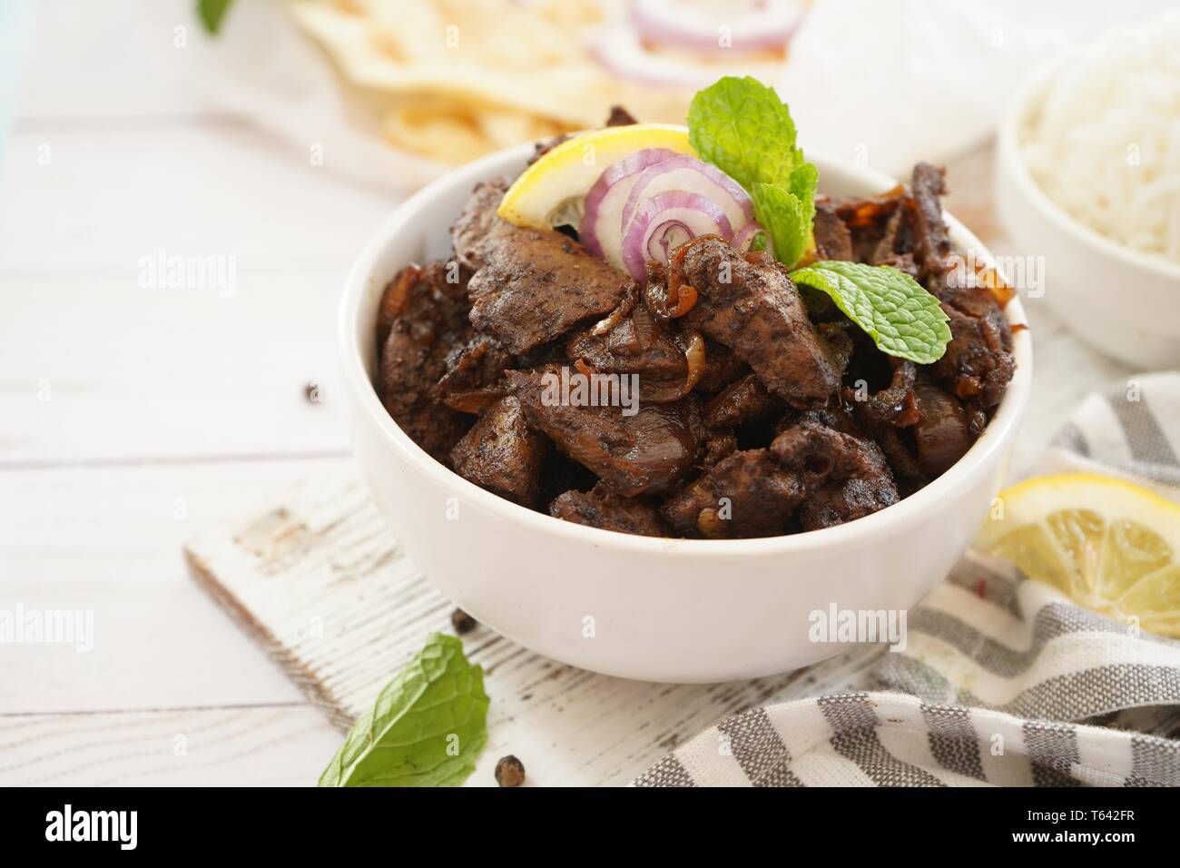 Beef Liver fry or roast served with rice and Roti, selective focus ...