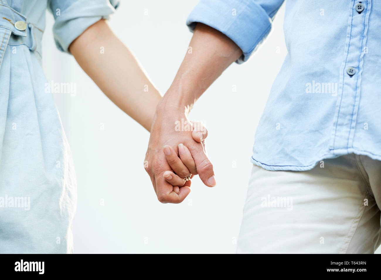 Family holding hands together closeup Stock Photo - Alamy