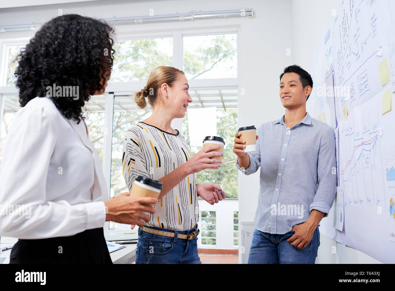 Coworker enjoying coffee break Stock Photo - Alamy