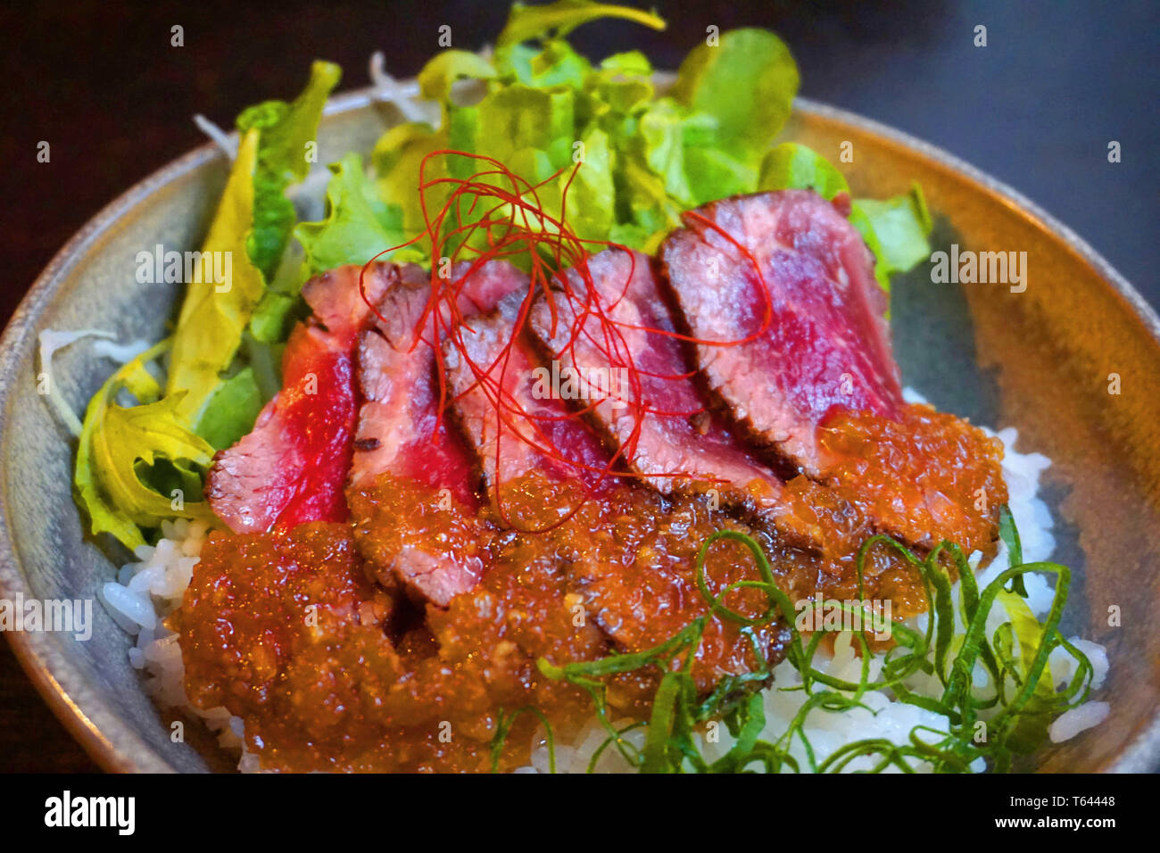 Delicious rice with medium rare beef and lettuce and ginger sauce ...