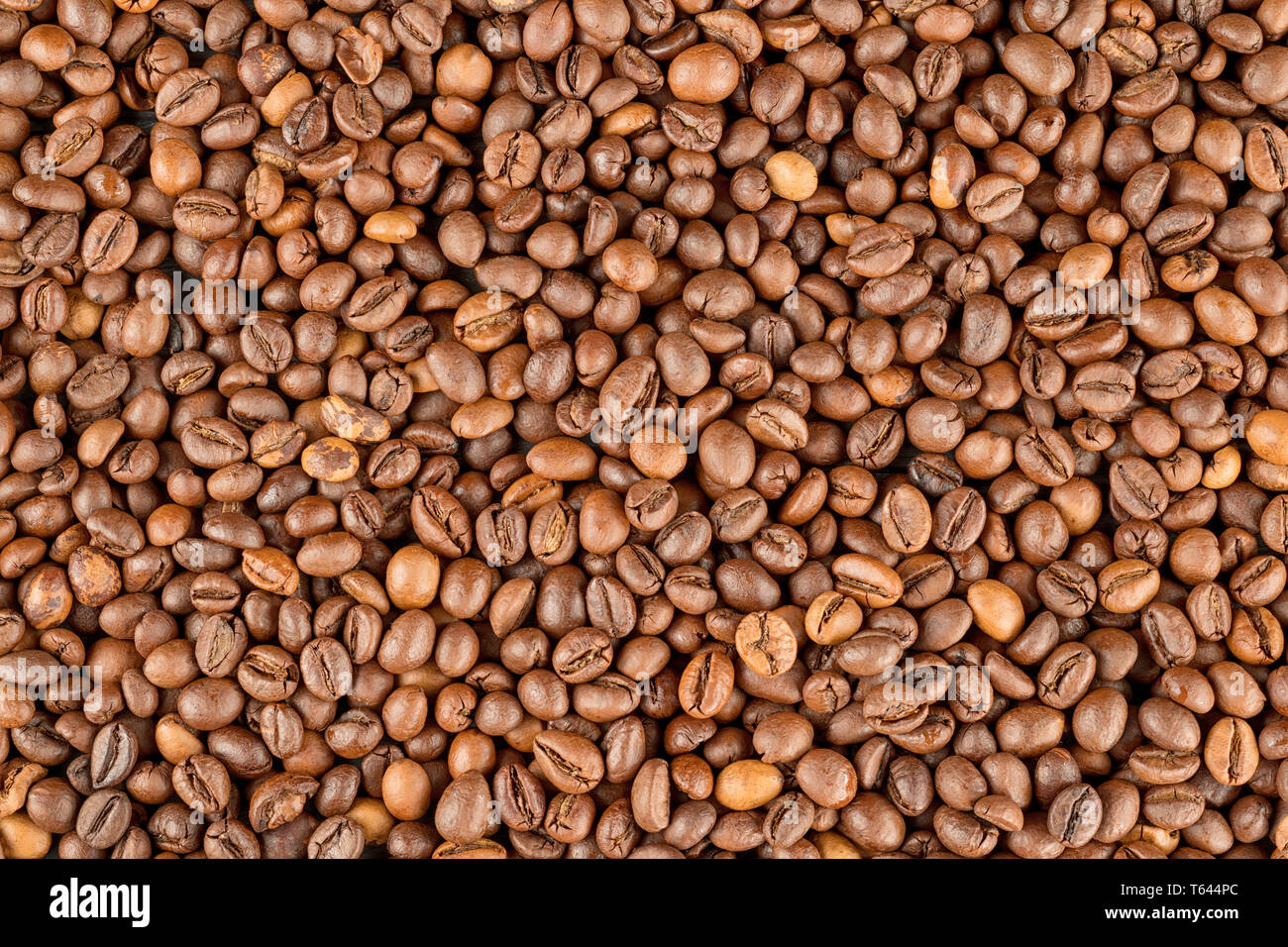 Raw coffee beans covered surface close up. Background and texture Stock ...