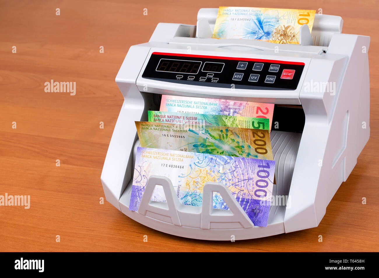 New Swiss Francs in a counting machine Stock Photo - Alamy