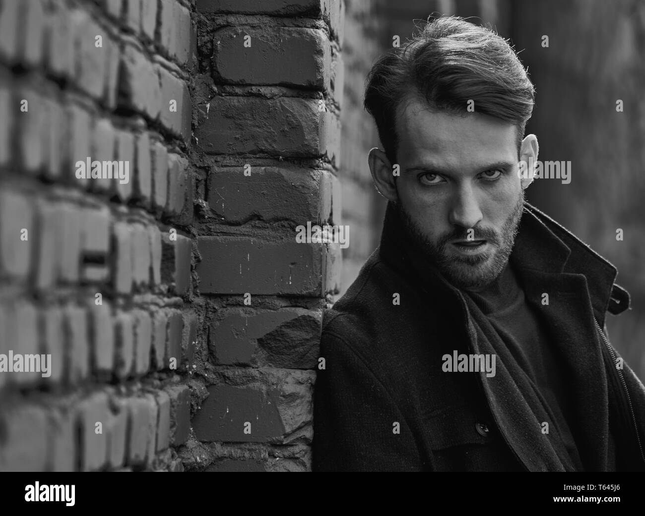 Angry beard bandit male looking serious outdoor on brick wall ...