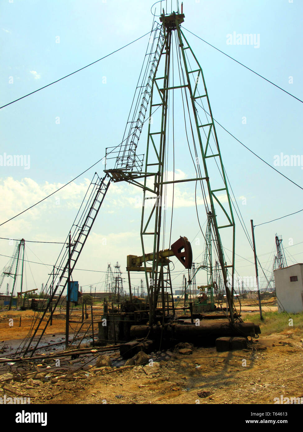 Abandoned oil rigs. Jacks of the oil pump. Machines for the extraction ...