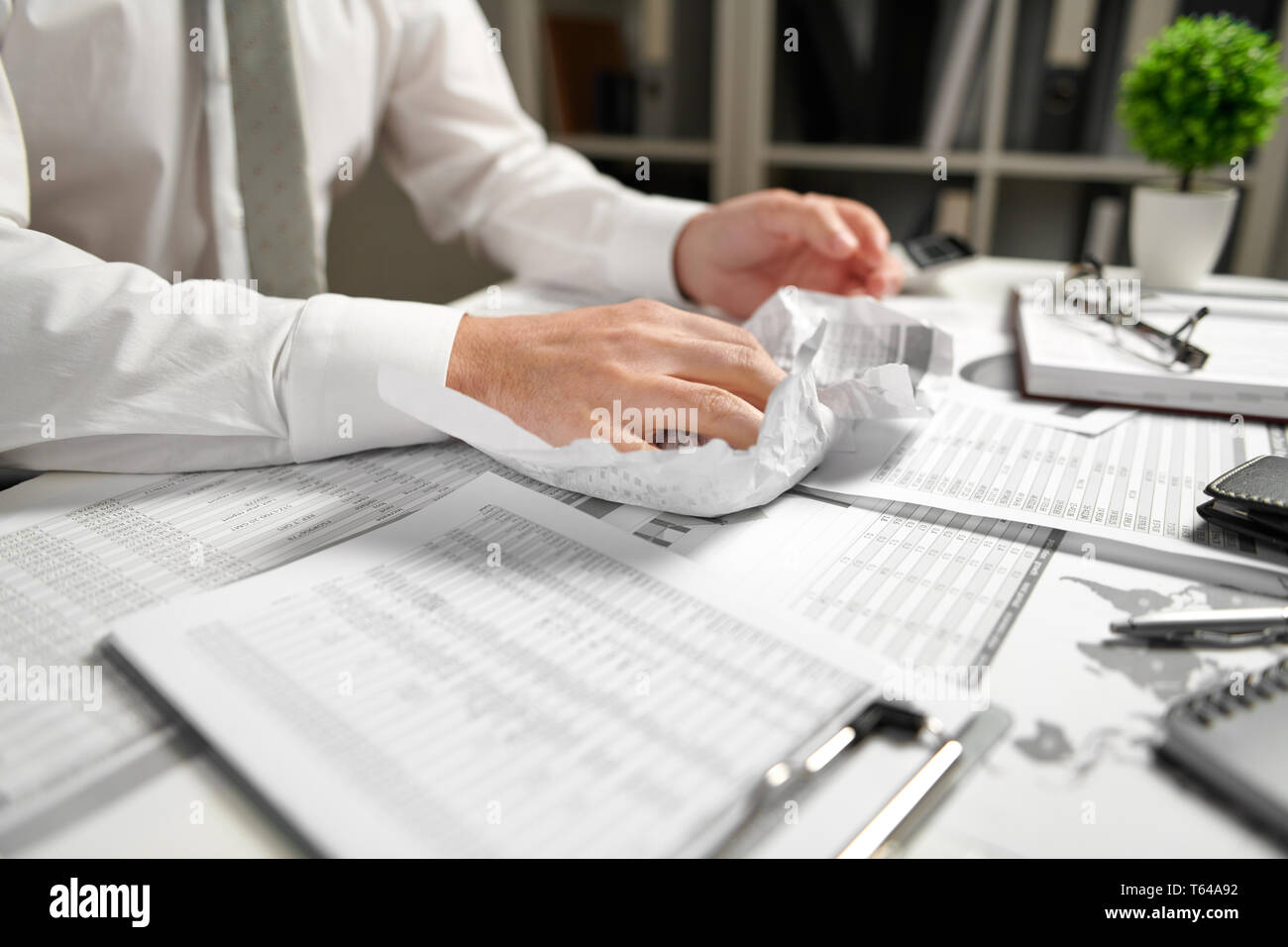 Angry businessman has stress and troubles with bad reports, he breaks ...