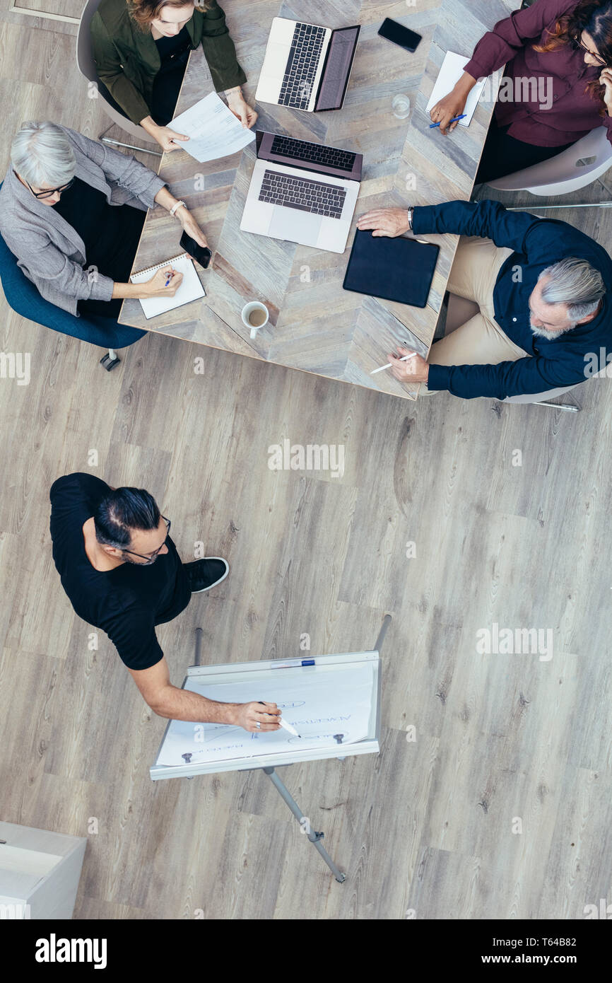 businessman giving presentation to colleagues at meeting. business ...