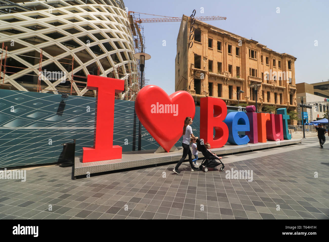 Beirut, Lebanon. 29th Apr, 2019. A woman with a pram walks past "I Love ...