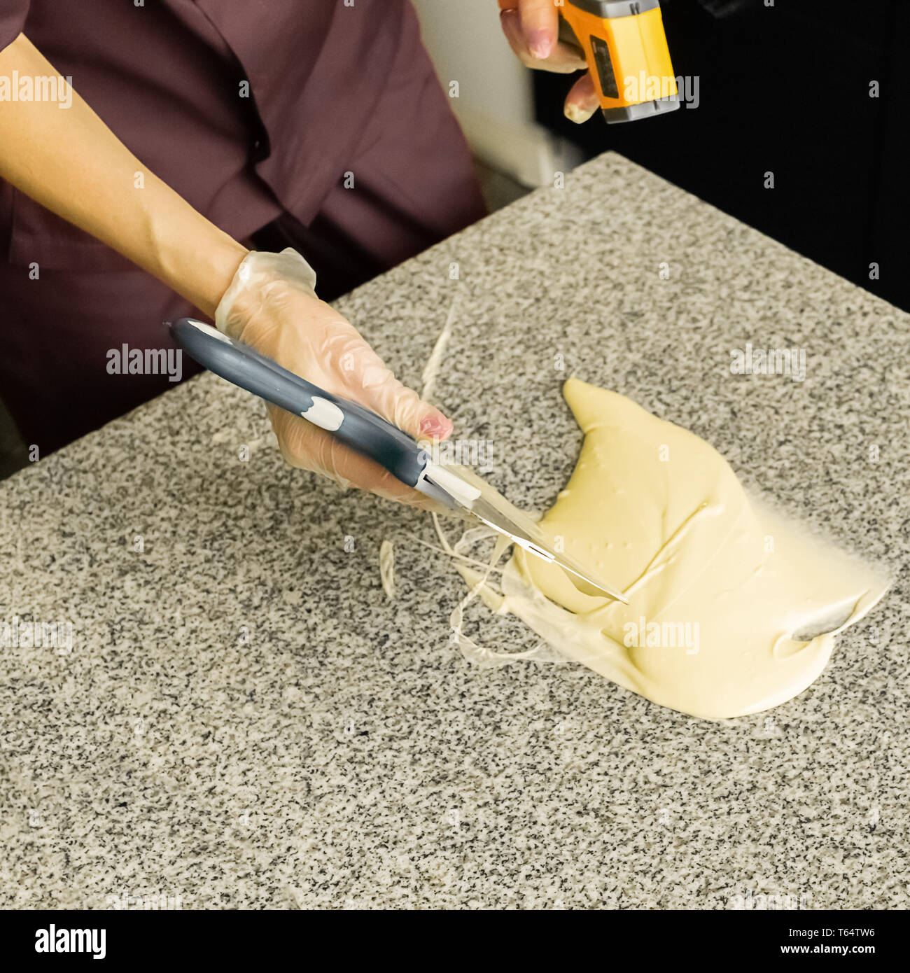 The process of making handmade chocolates. Tempering white chocolate ...