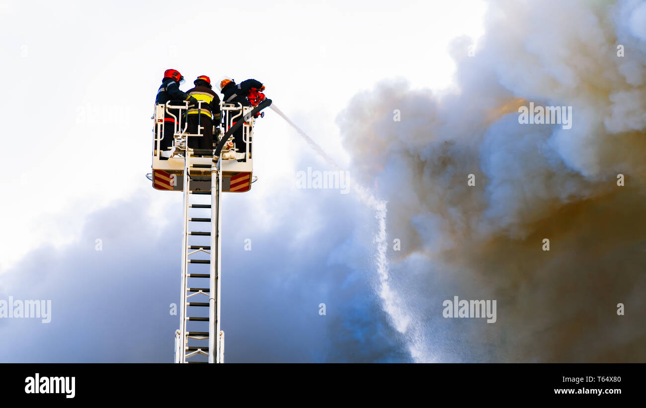 Firefighters extinguish a big fire Stock Photo - Alamy