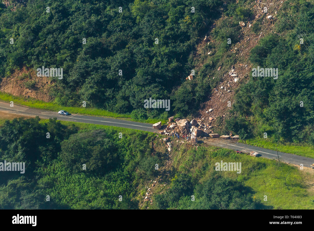 Rural Valley road route blocked with large rocks avalanche off overhead ...