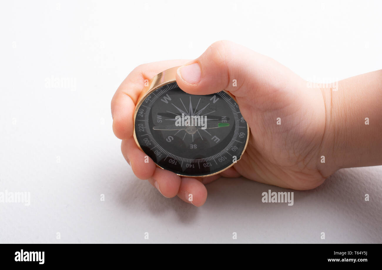 Compass tool in toddler hand on white Stock Photo - Alamy