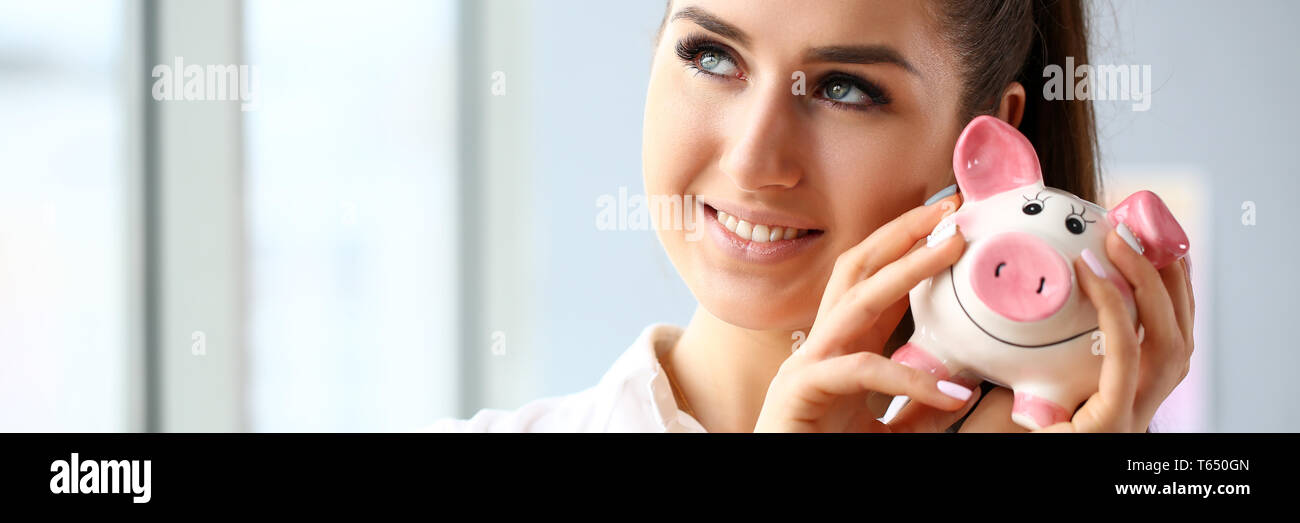Happy beautiful woman shake in arms funny piggybank Stock Photo - Alamy