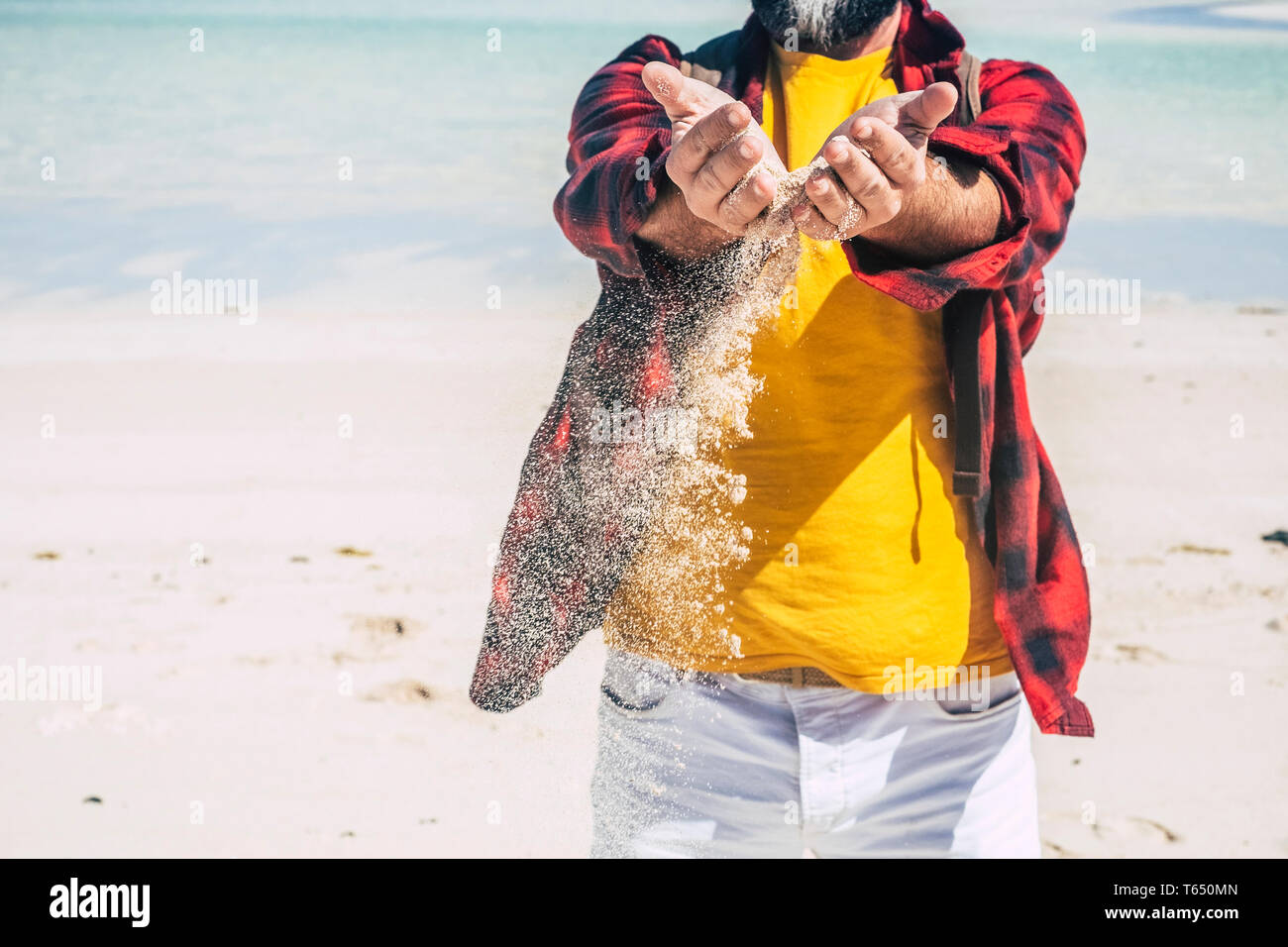 Travel and summer holiday vacation with man holding sand on hands ...