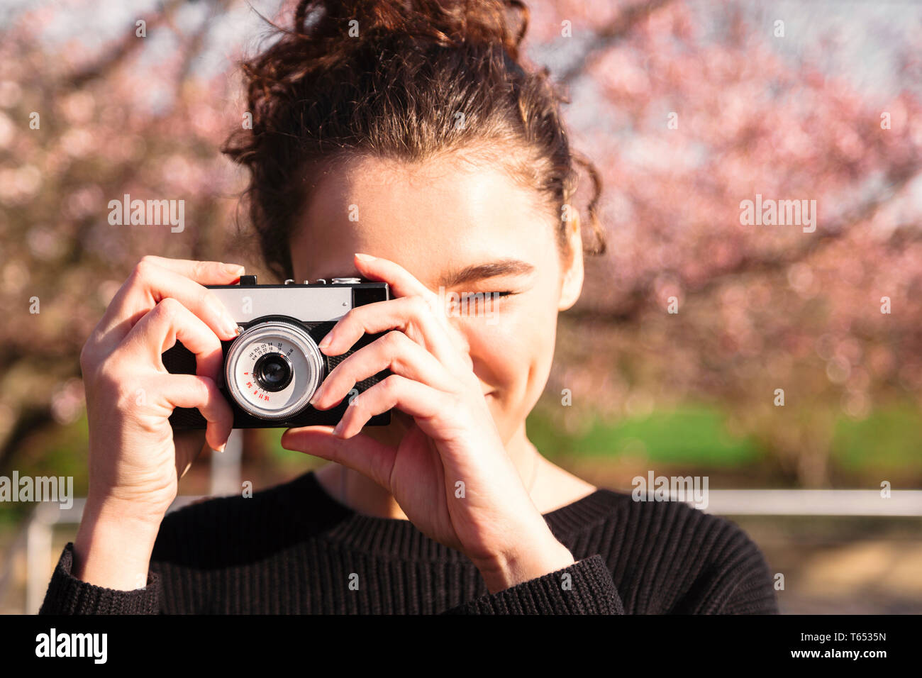 Girl looks into camera lens and smiles on nature Stock Photo - Alamy