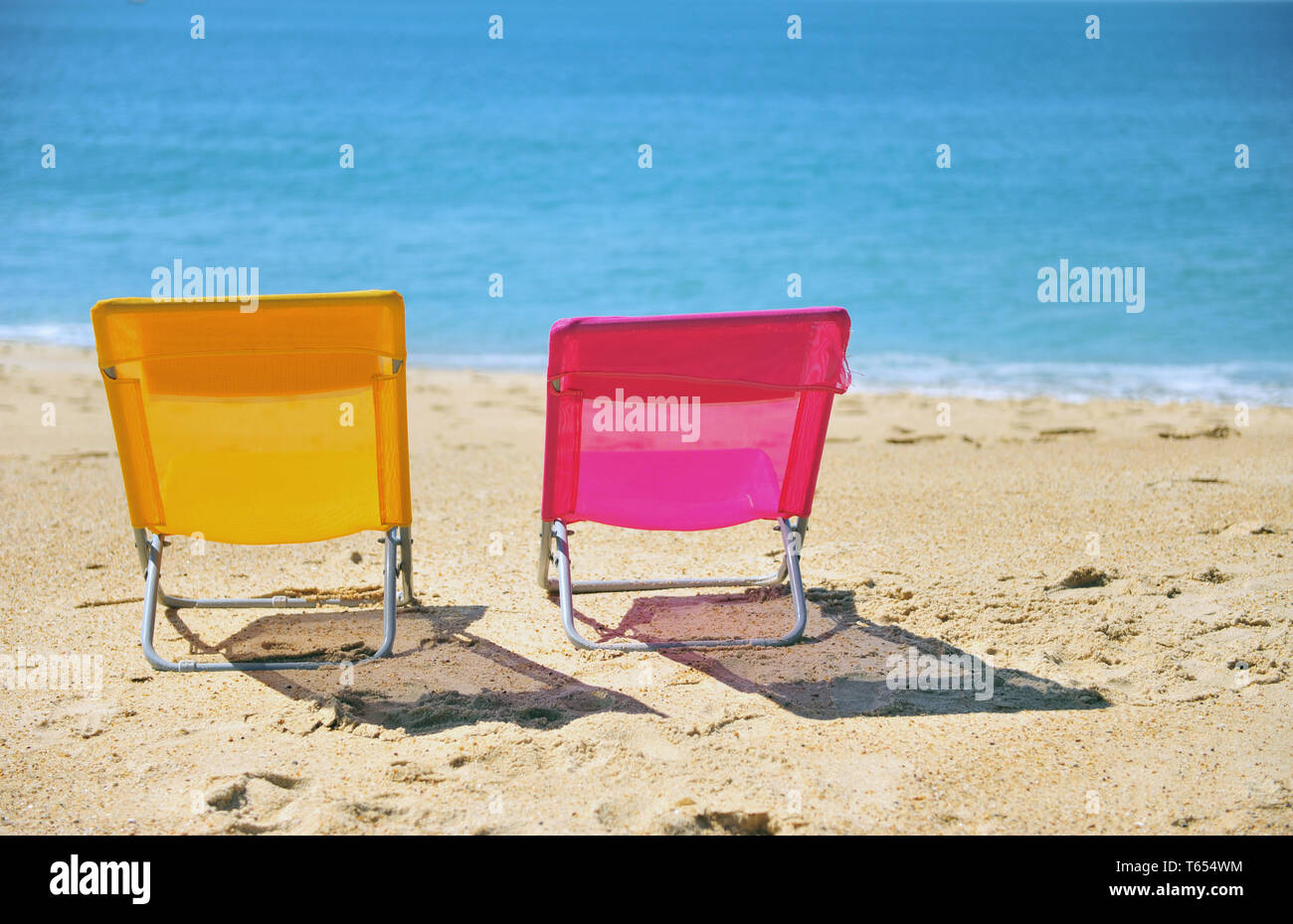 Two colorful beach chairs with blue sea water on background Stock Photo ...