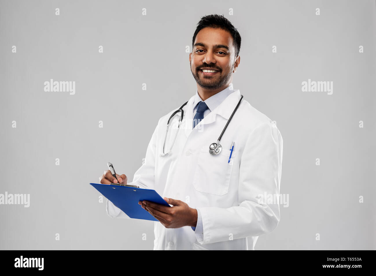 indian male doctor with clipboard and stethoscope Stock Photo - Alamy
