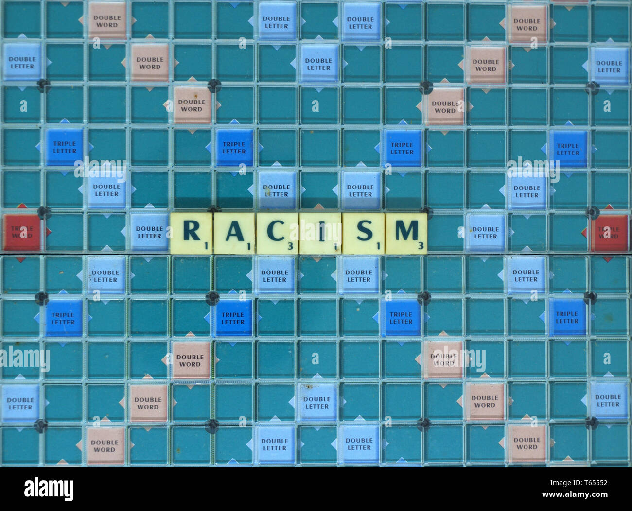 Racism written in Scrabble tiles Stock Photo - Alamy