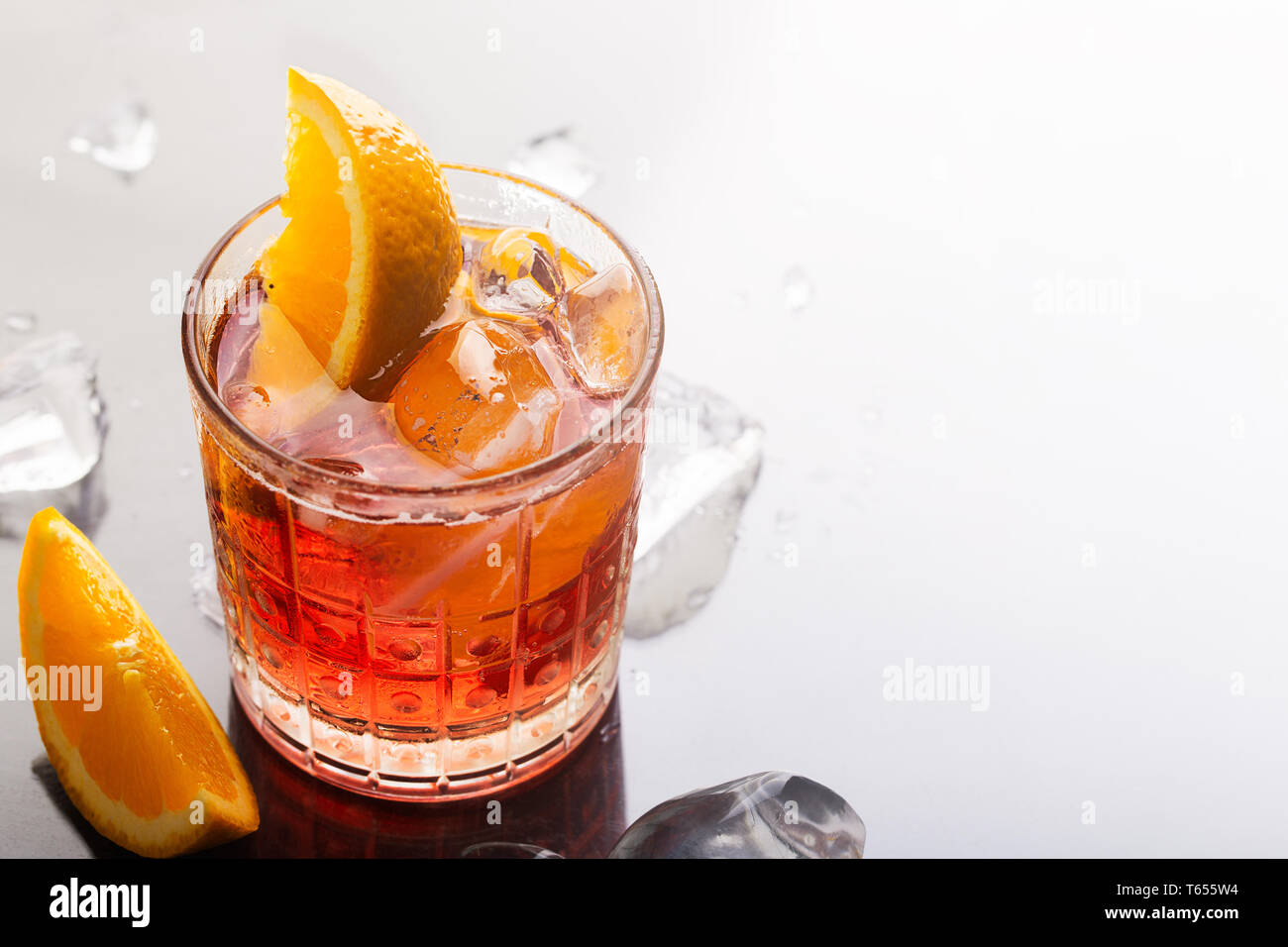 Fresh red colorful alcoholic cocktail Aperol Spritz with orange and ice ...