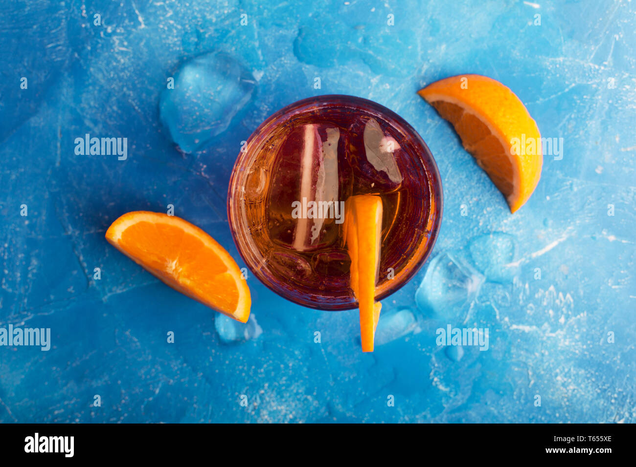 Fresh ice tea summer cocktail with orange and ice in glass. Top view ...