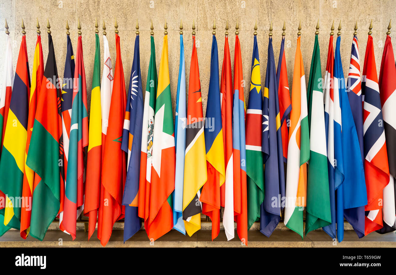 Some world national flags on poles on a wall Stock Photo - Alamy