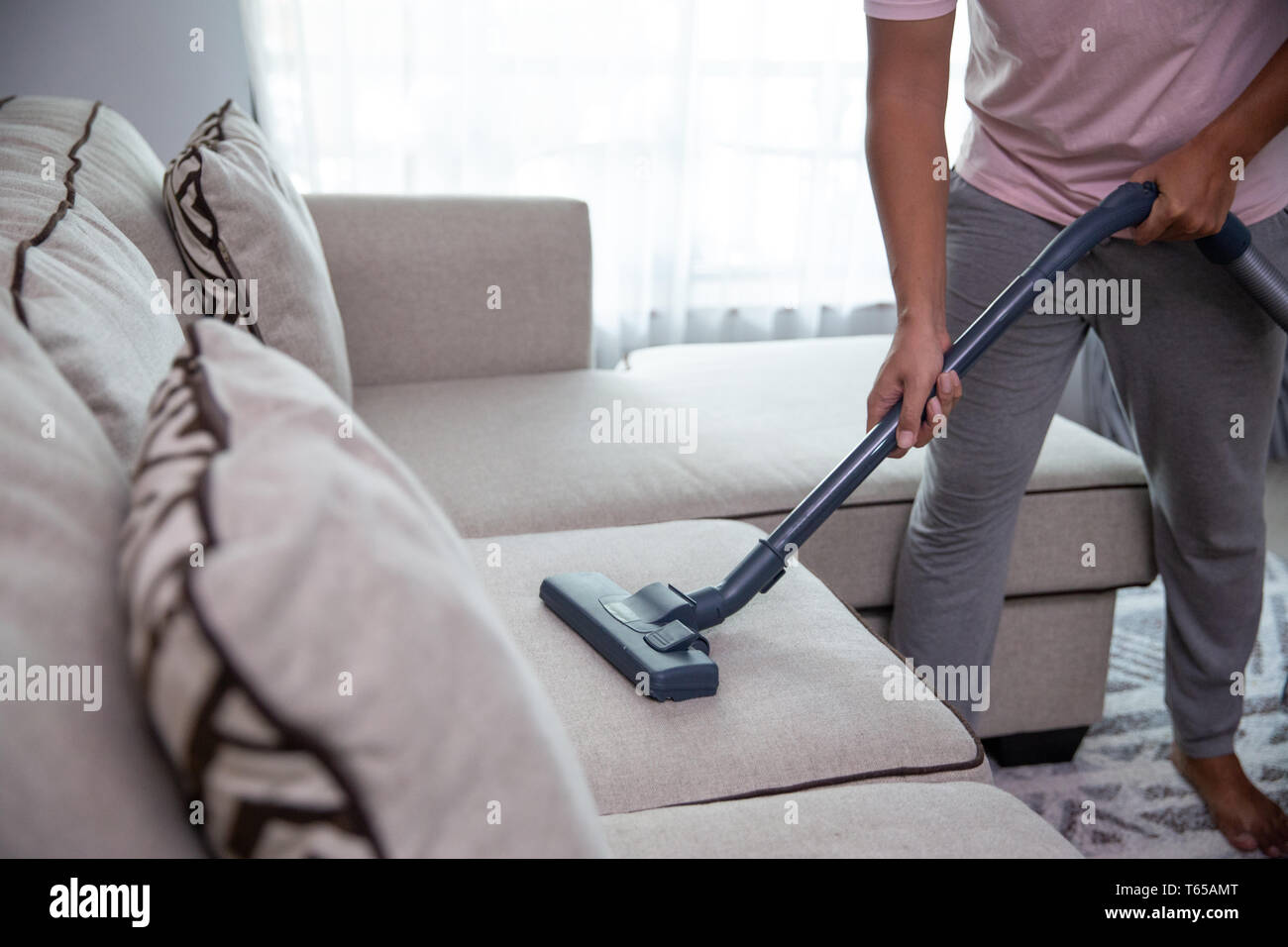man using vacuum cleaner Stock Photo - Alamy