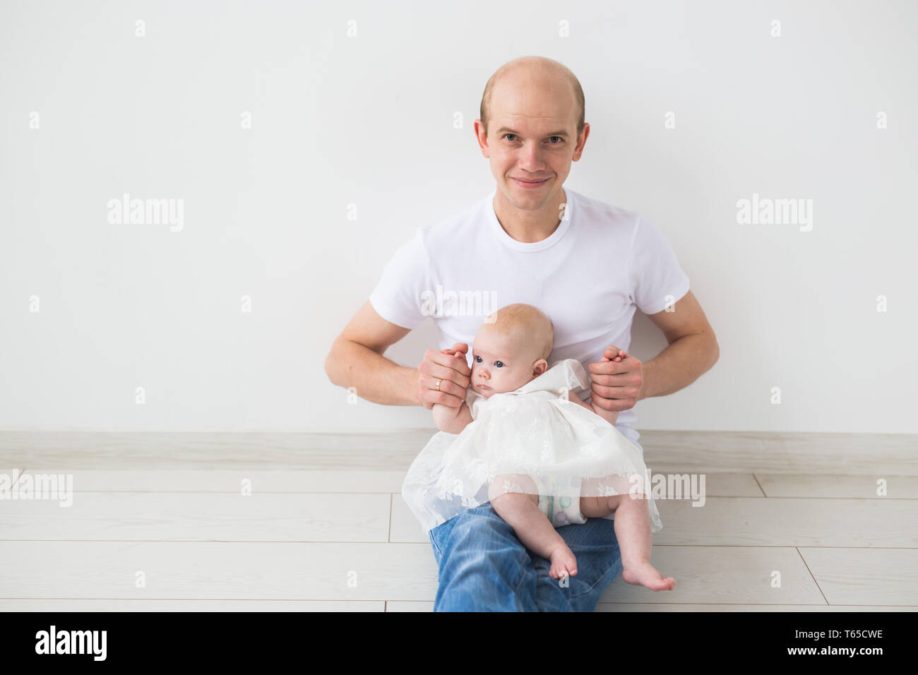 Parenting, family and fatherhood concept - Bald father hugging his ...