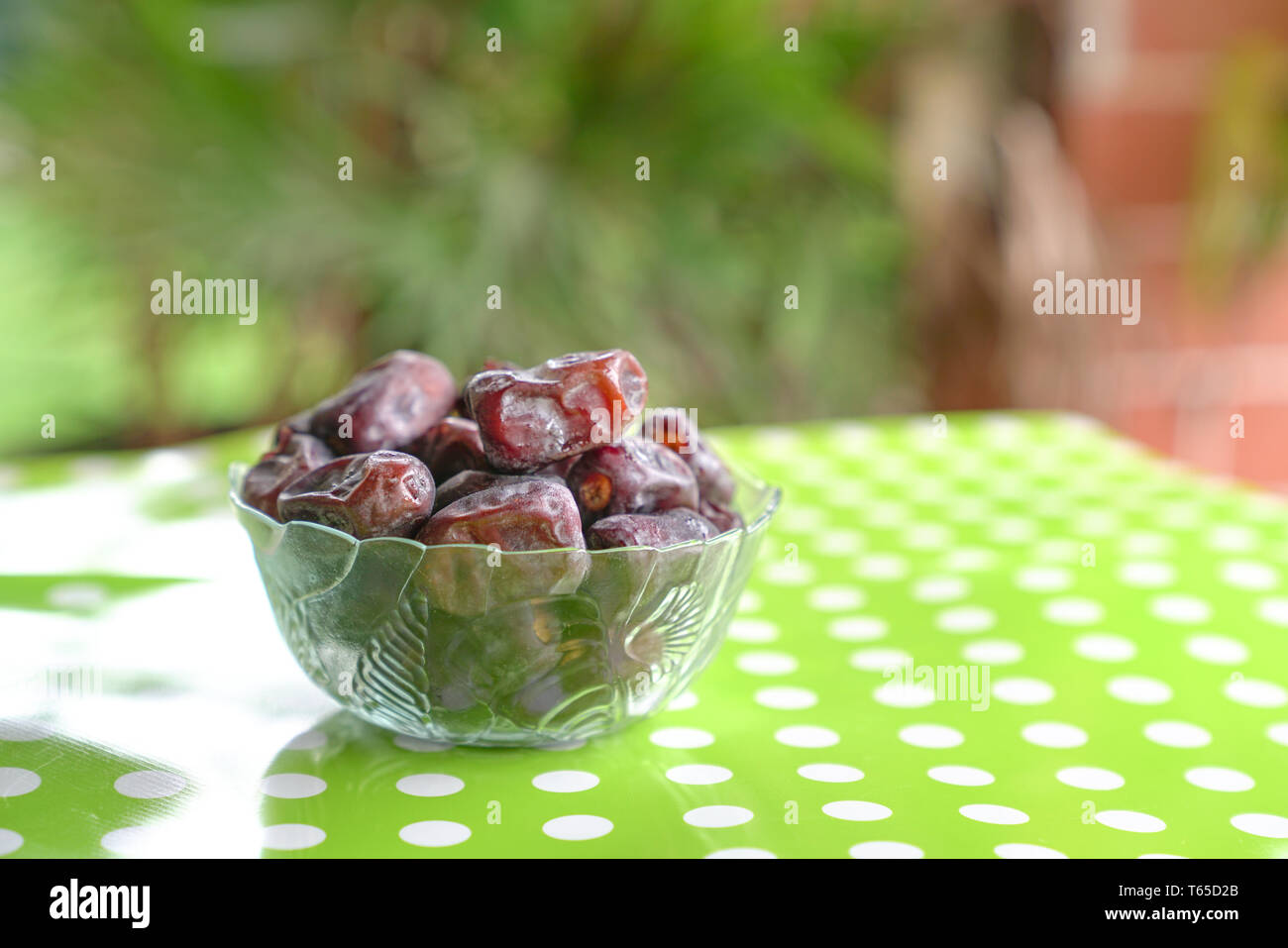 Dates fruit in a glass bowl. Eid Mubarak or Ramadan kareem concept ...