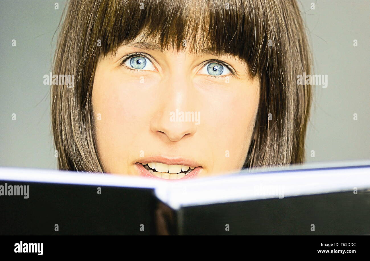 Young lady reading a book Stock Photo - Alamy