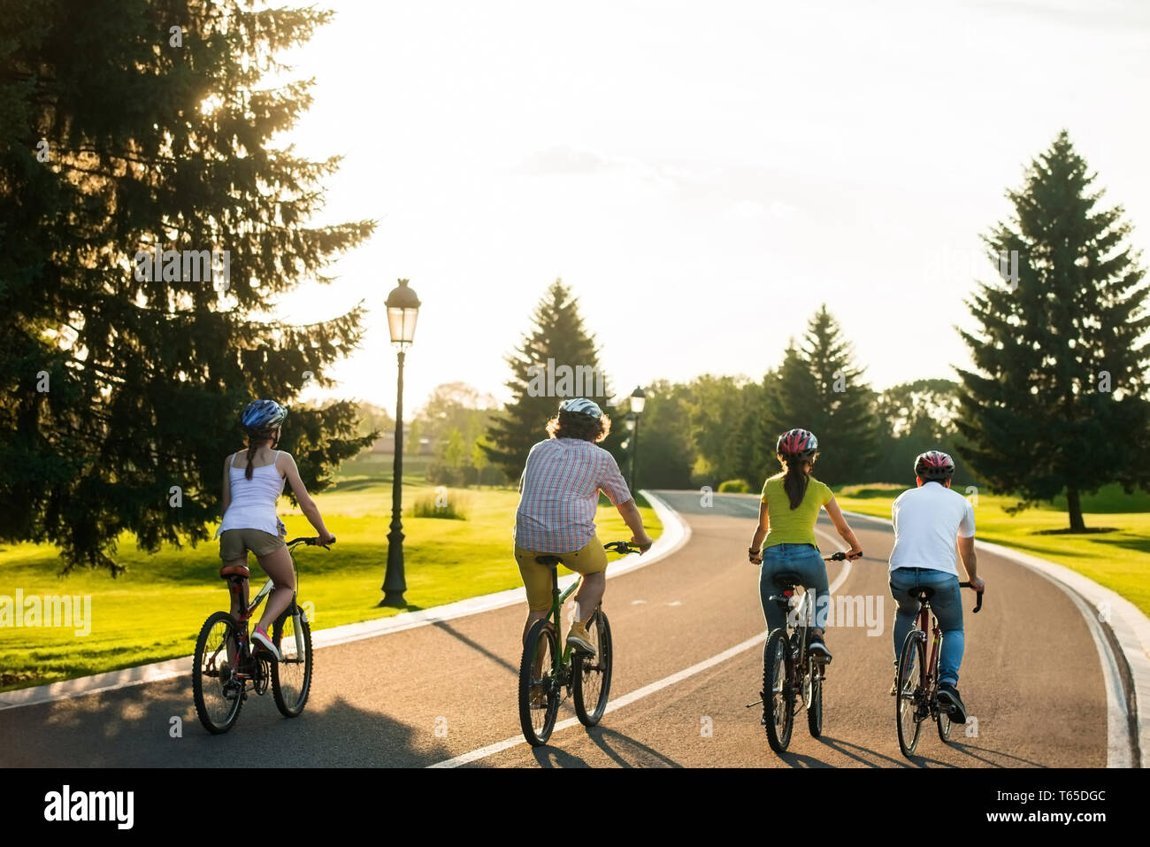 Students riding on bikes, back view Stock Photo - Alamy
