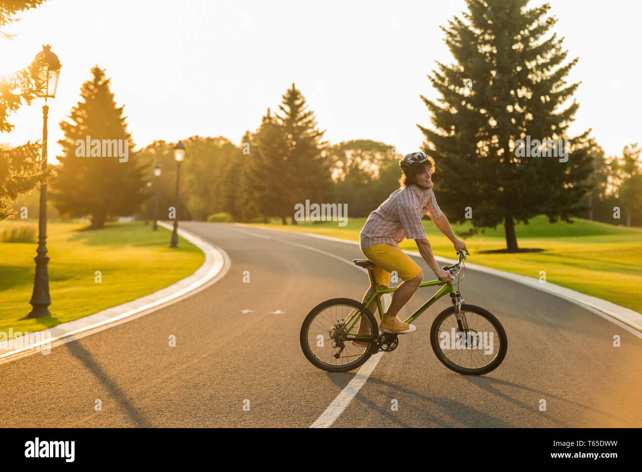 Happy guy having fun riding bike outdoors Stock Photo - Alamy