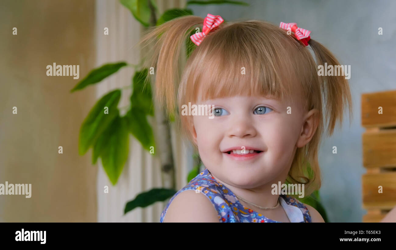 Portrait of funny shy little girl at home Stock Photo - Alamy
