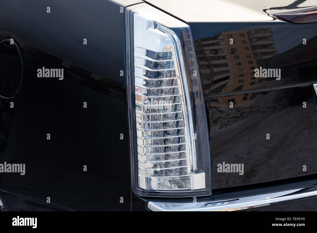 Close-up on the rear LED brake light of white color on a black car in ...